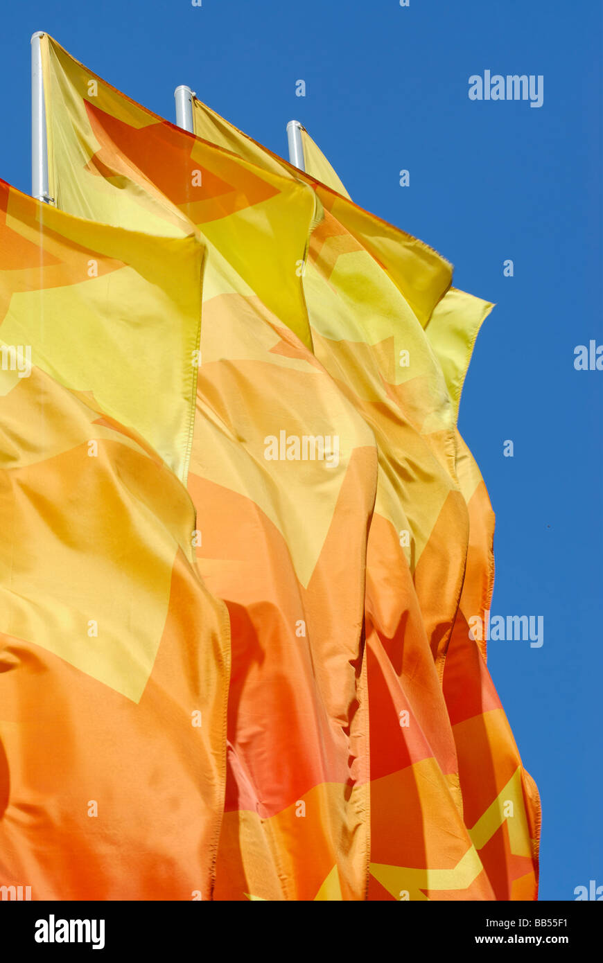 Celebratory orange flags on the blue sky background Stock Photo - Alamy