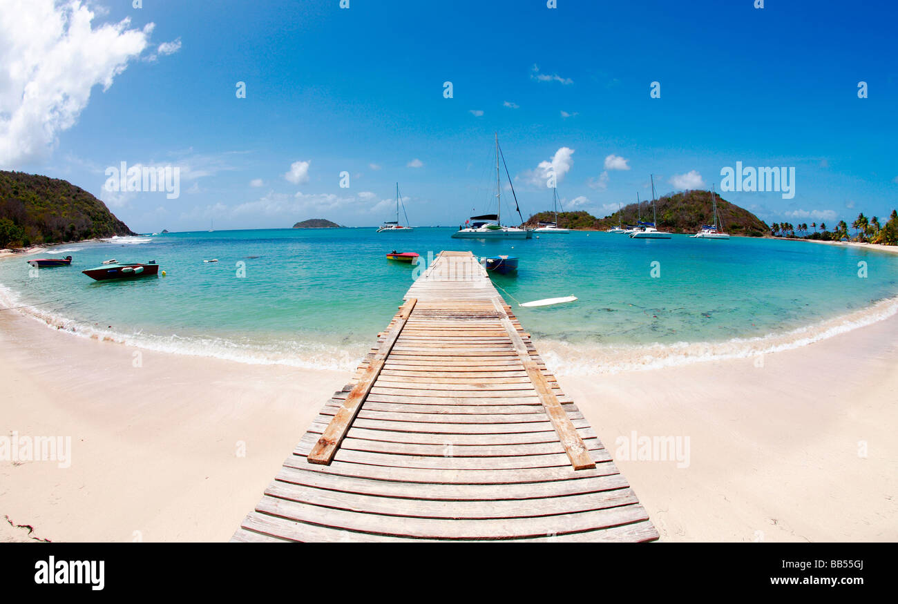 Jetty on beach with boats Stock Photo - Alamy
