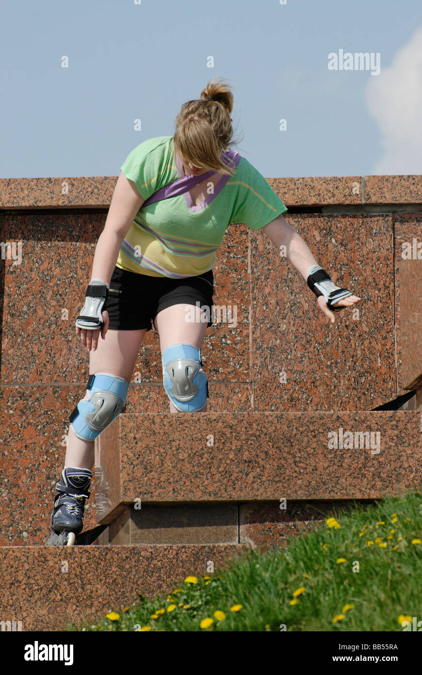 Girls on rollers tries to come downstairs Stock Photo - Alamy