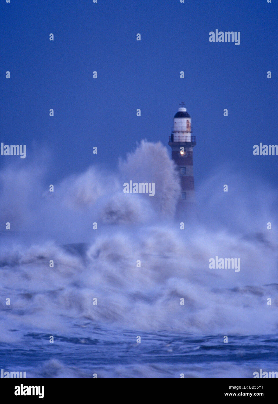 Huge waves surround the lighthouse on Roker Pier in Sunderland, England ...