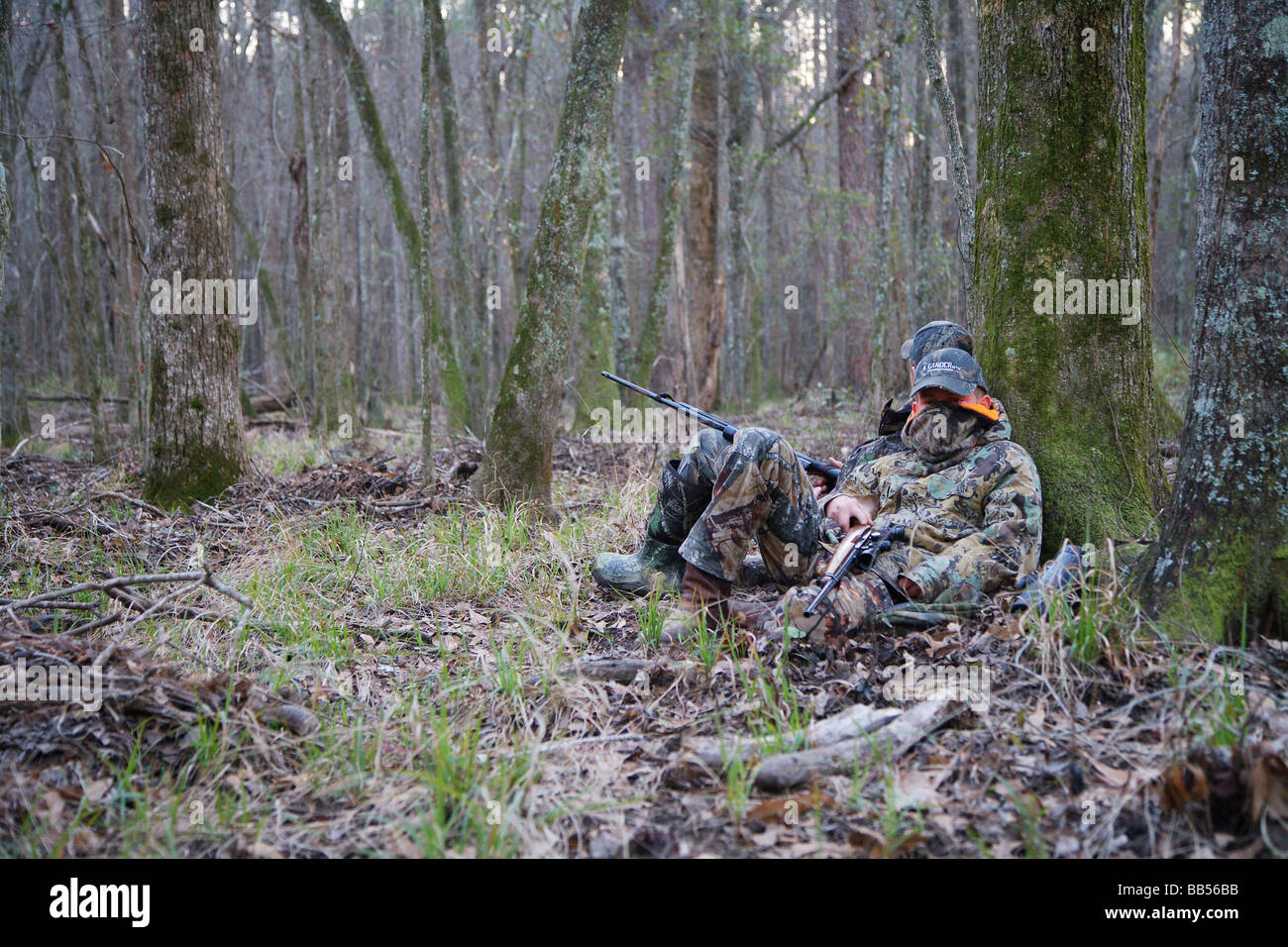 Hunter resting against tree looking hi-res stock photography and images ...