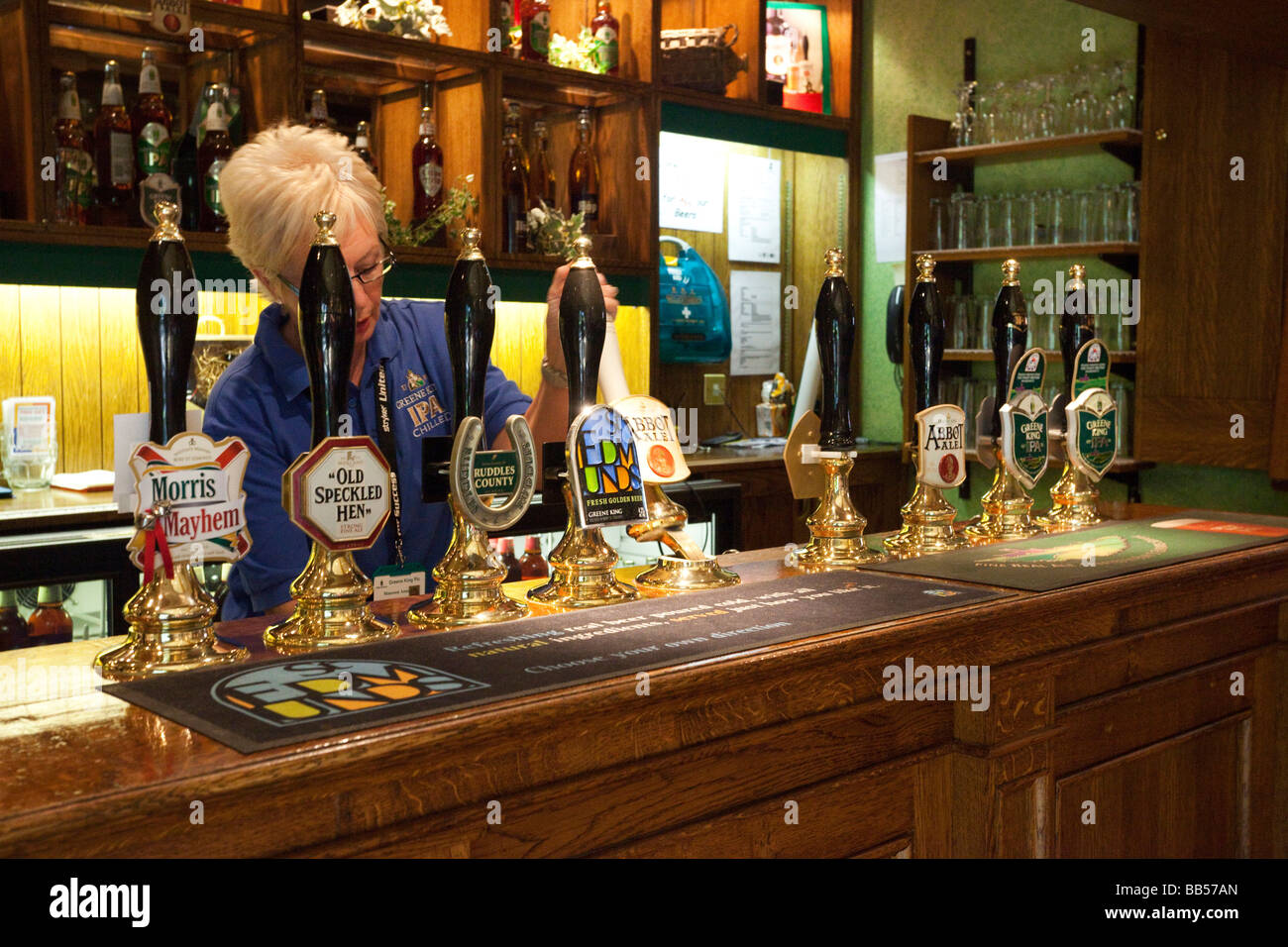 woman serving behind a bar Stock Photo - Alamy