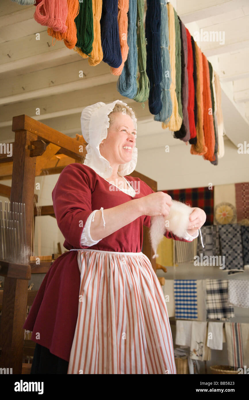 A period actor plays the role of a weaver in Colonial Williamsburg ...