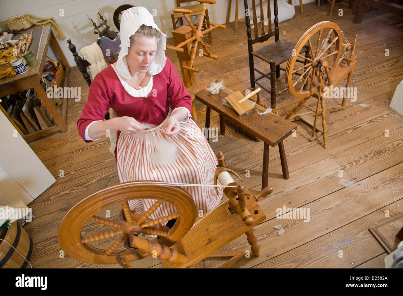 A period actor plays the role of a weaver in Colonial Williamsburg ...