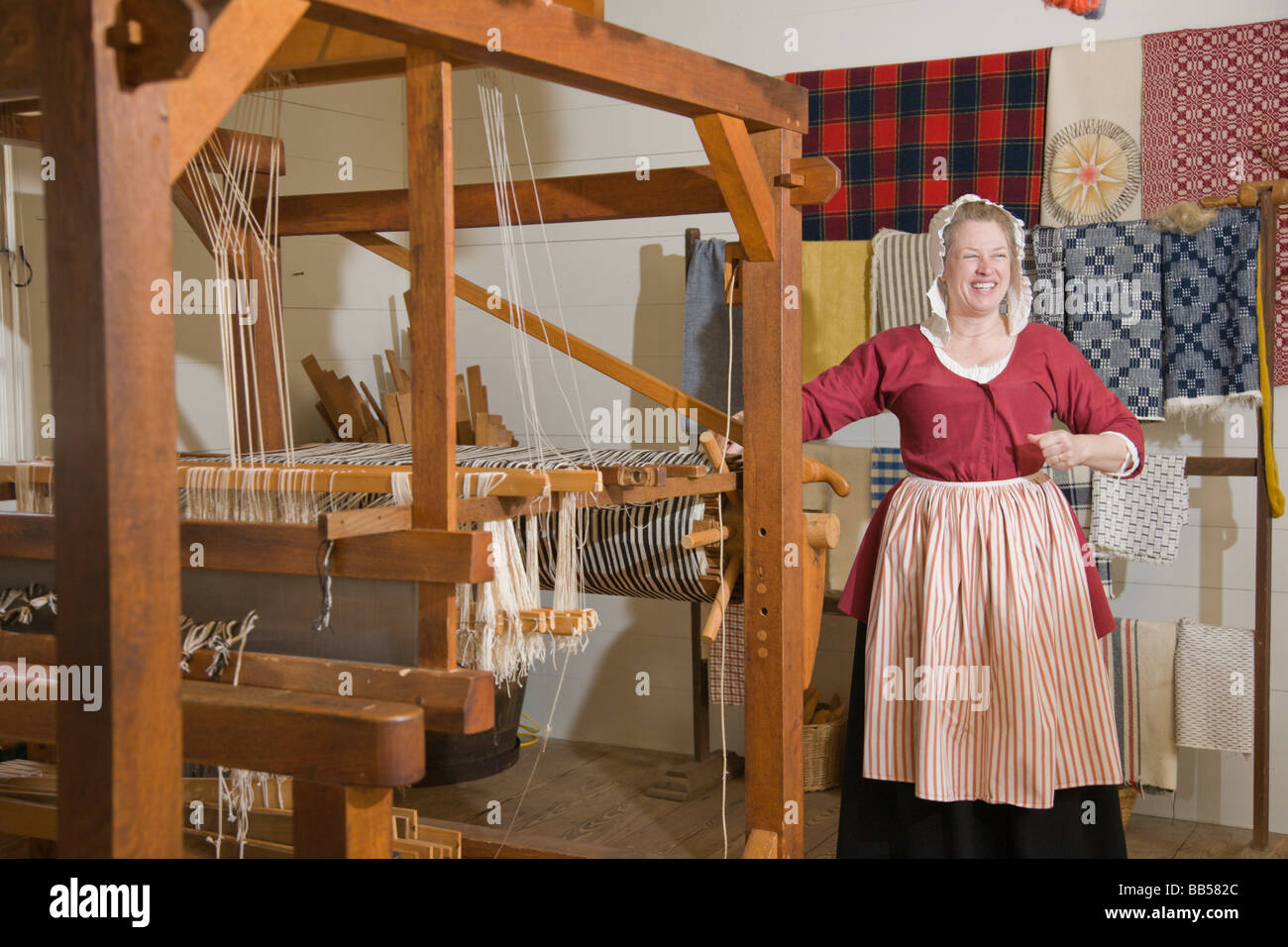 A period actor plays the role of a weaver in Colonial Williamsburg ...