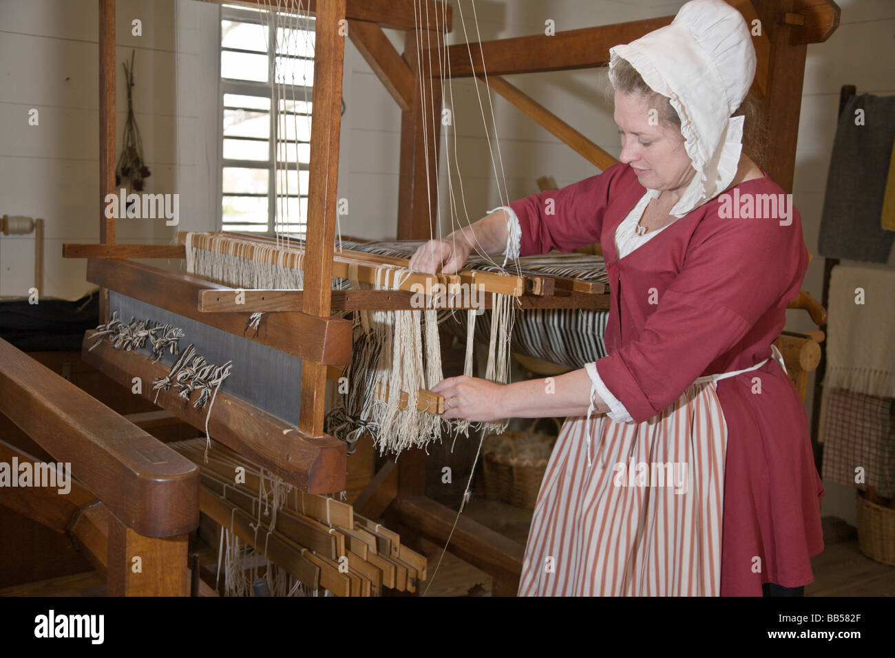A period actor plays the role of a weaver in Colonial Williamsburg ...