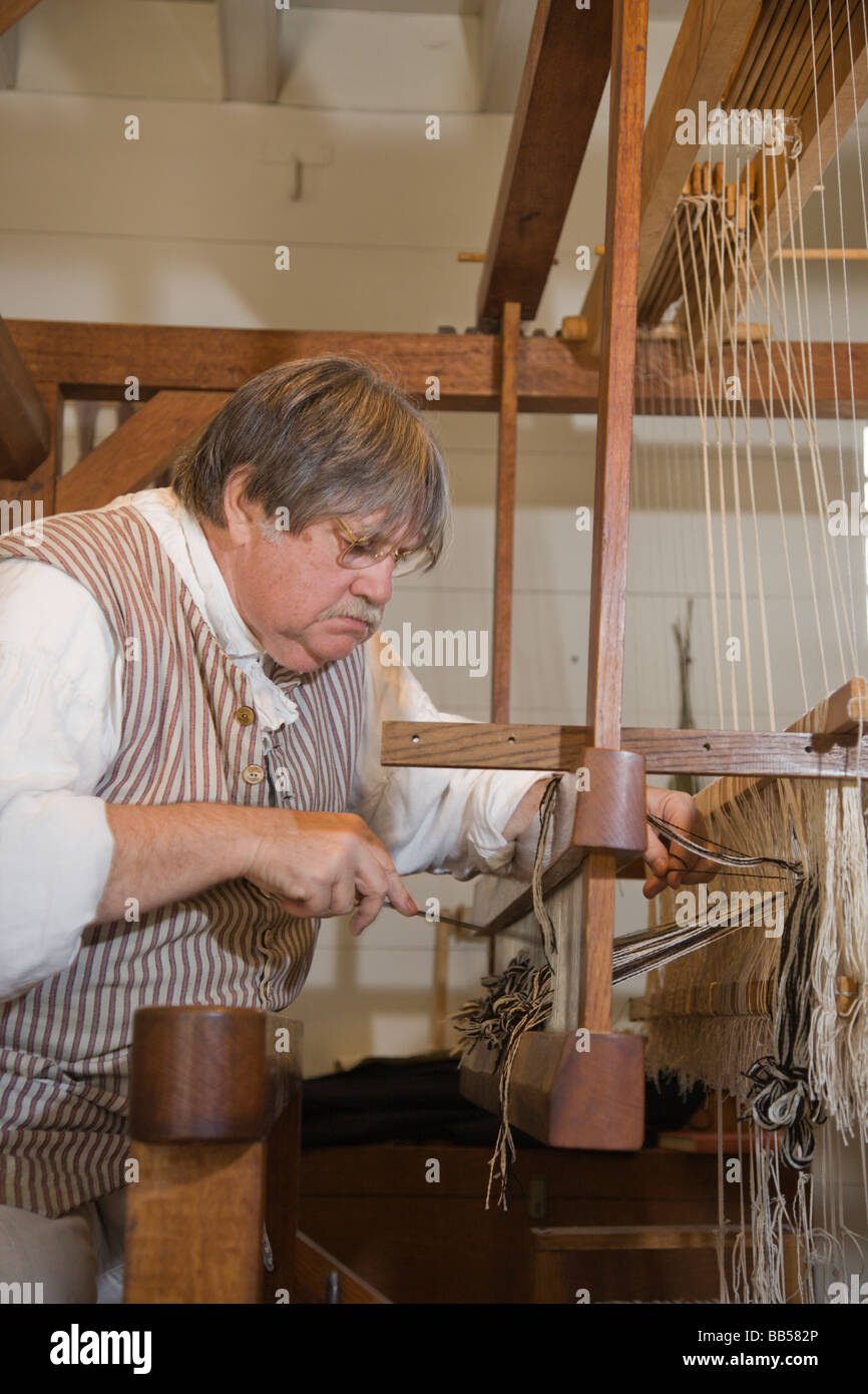 A period actor plays the role of a weaver in Colonial Williamsburg ...