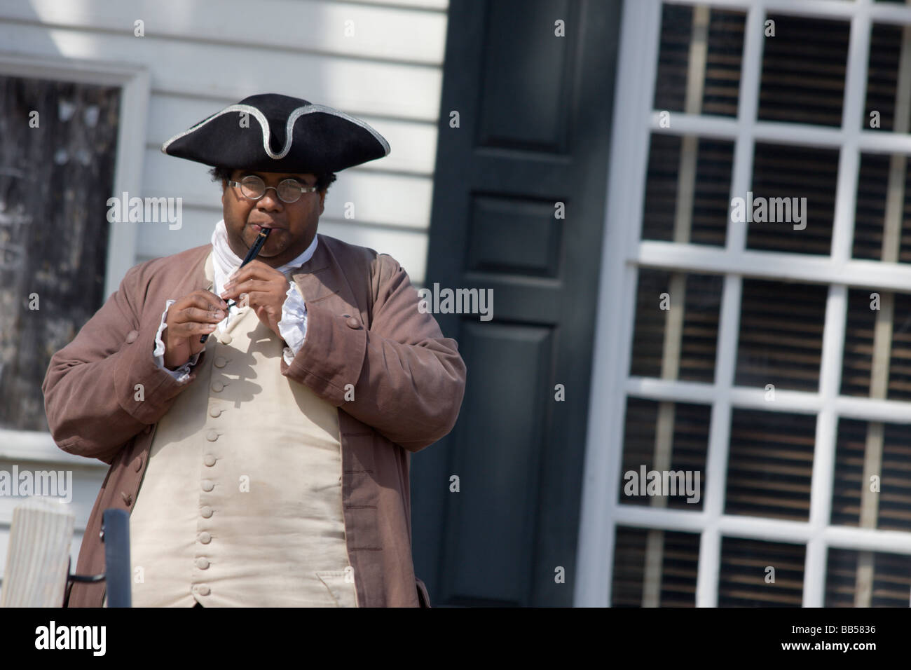 A period actor in Colonial Williamsburg, Virginia plays a flute Stock ...