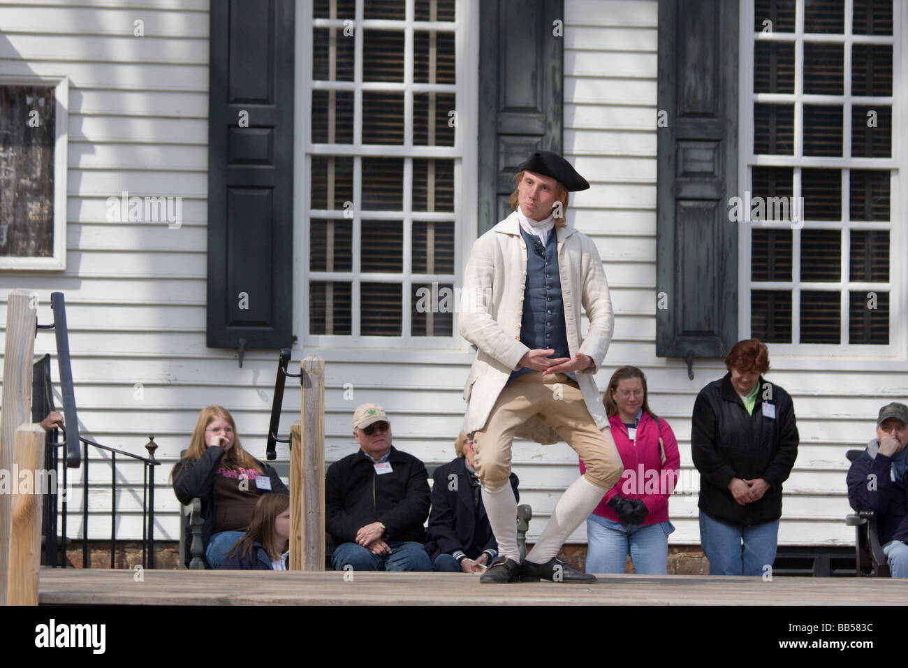 A period actor in Colonial Williamsburg, Virginia shows female visitors ...