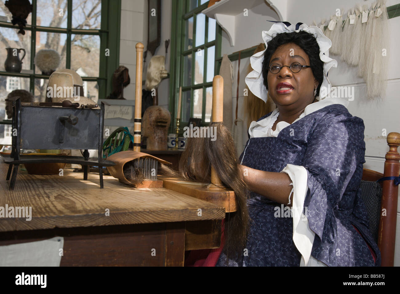A woman makes a wig in the Barber & Peruke Maker Shop at Colonial ...