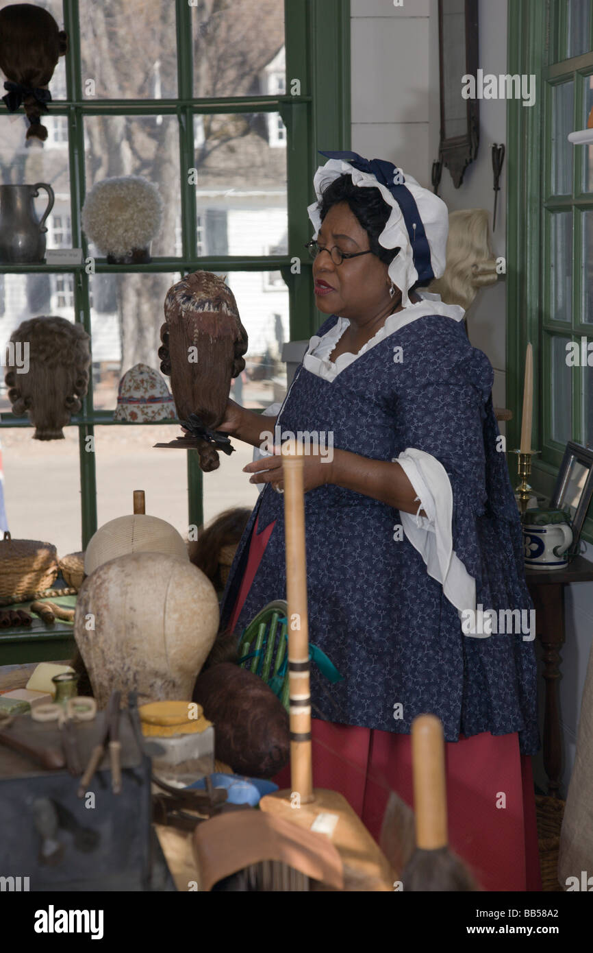 A woman portrays a colonial wigmaker in the Barber & Peruke Shop at ...