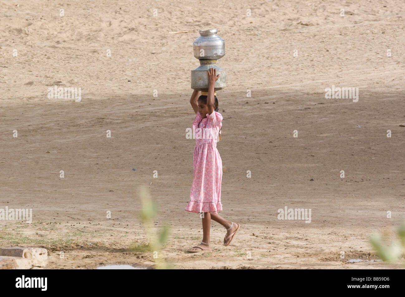 India Rajasthan Masuria young girls carrying water from the well back ...
