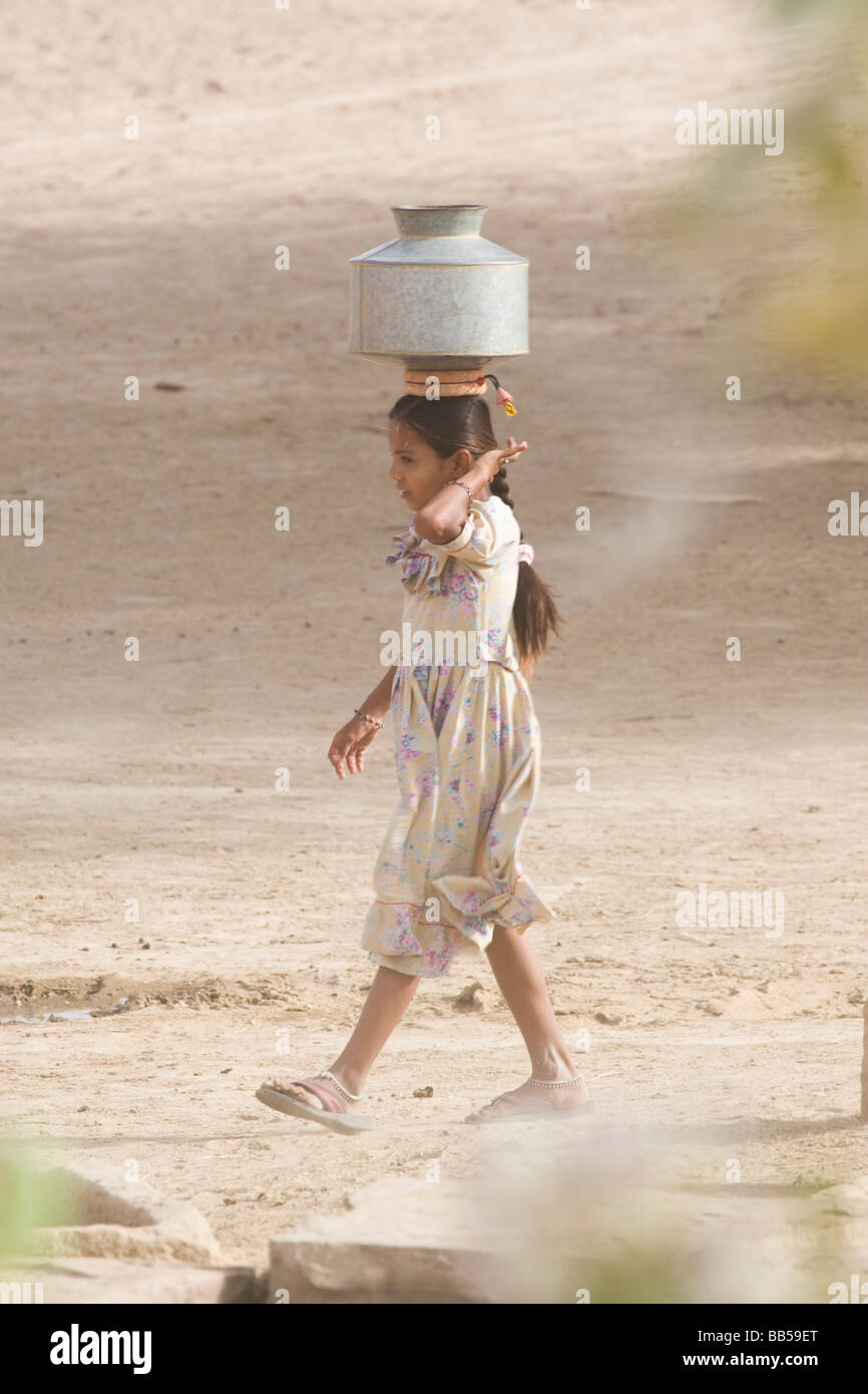 India Rajasthan Masuria young girls carrying water from the well back ...
