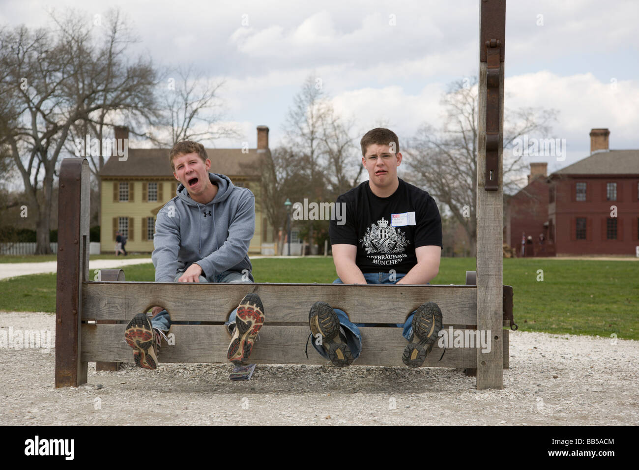 Teenage boys pretend to be locked in the stockade at Colonial ...