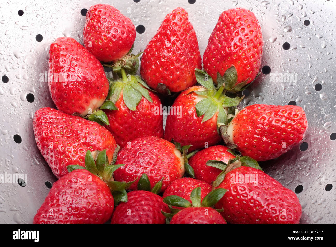 Fresh strawberries in steel colander Stock Photo - Alamy