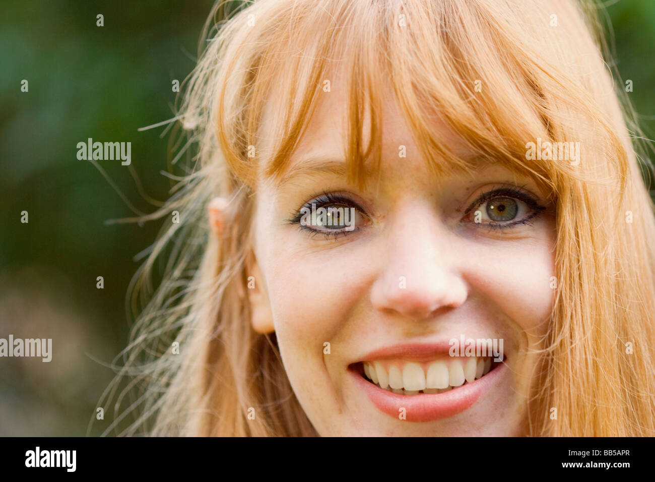 Red haired woman smiling Stock Photo - Alamy