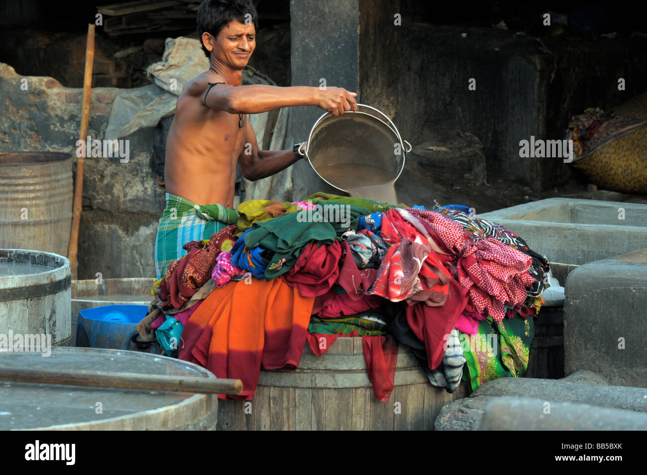 Dhobi Wallah adding chemicals to clothes in the washing process at ...
