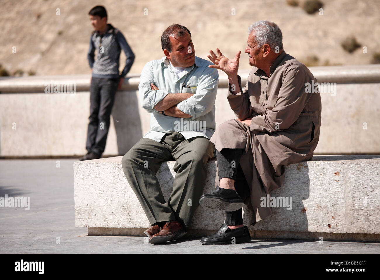Two men talking outside the Citadel, Aleppo, Syria Stock Photo - Alamy