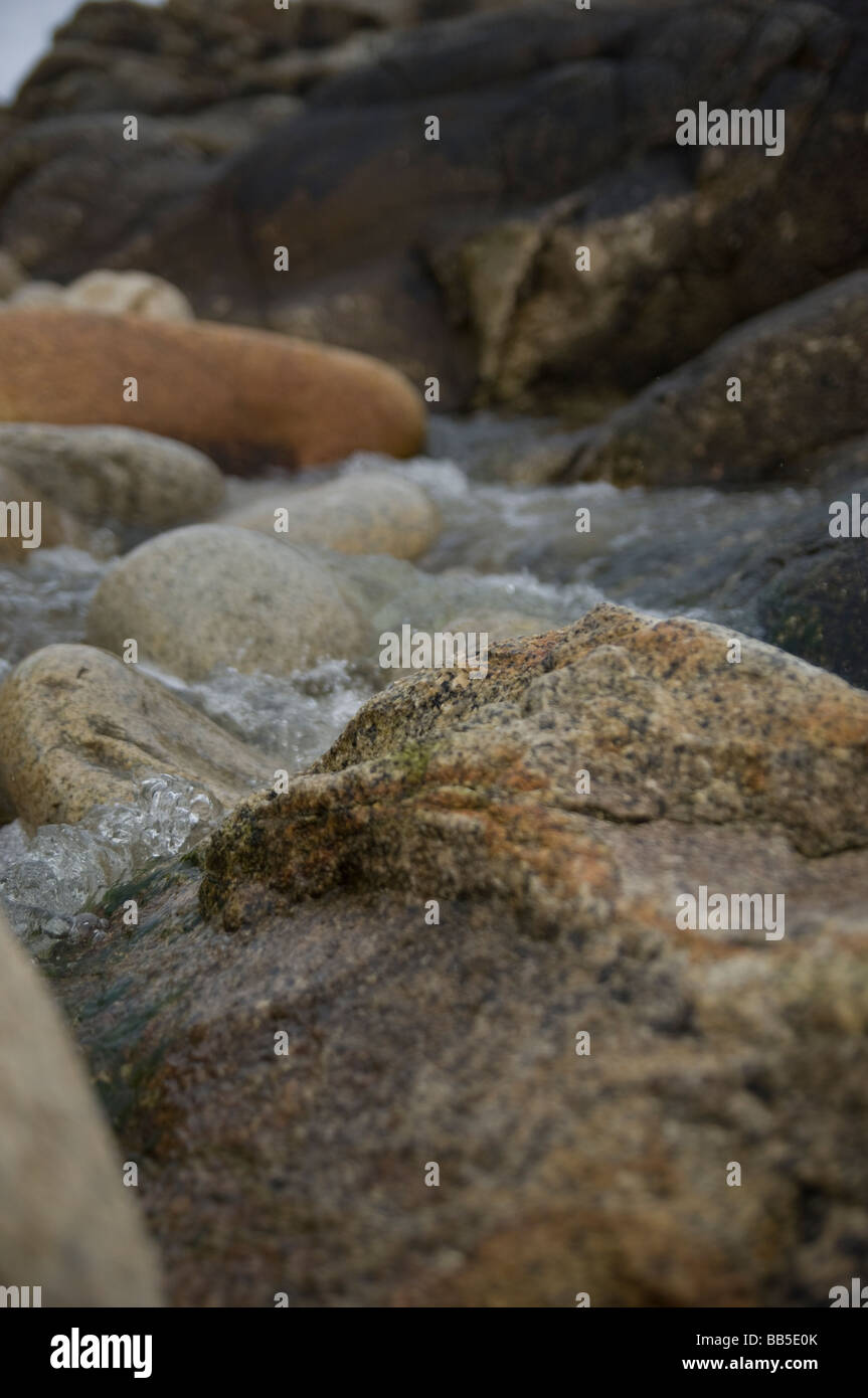 a stream of water flowing over stones Stock Photo - Alamy
