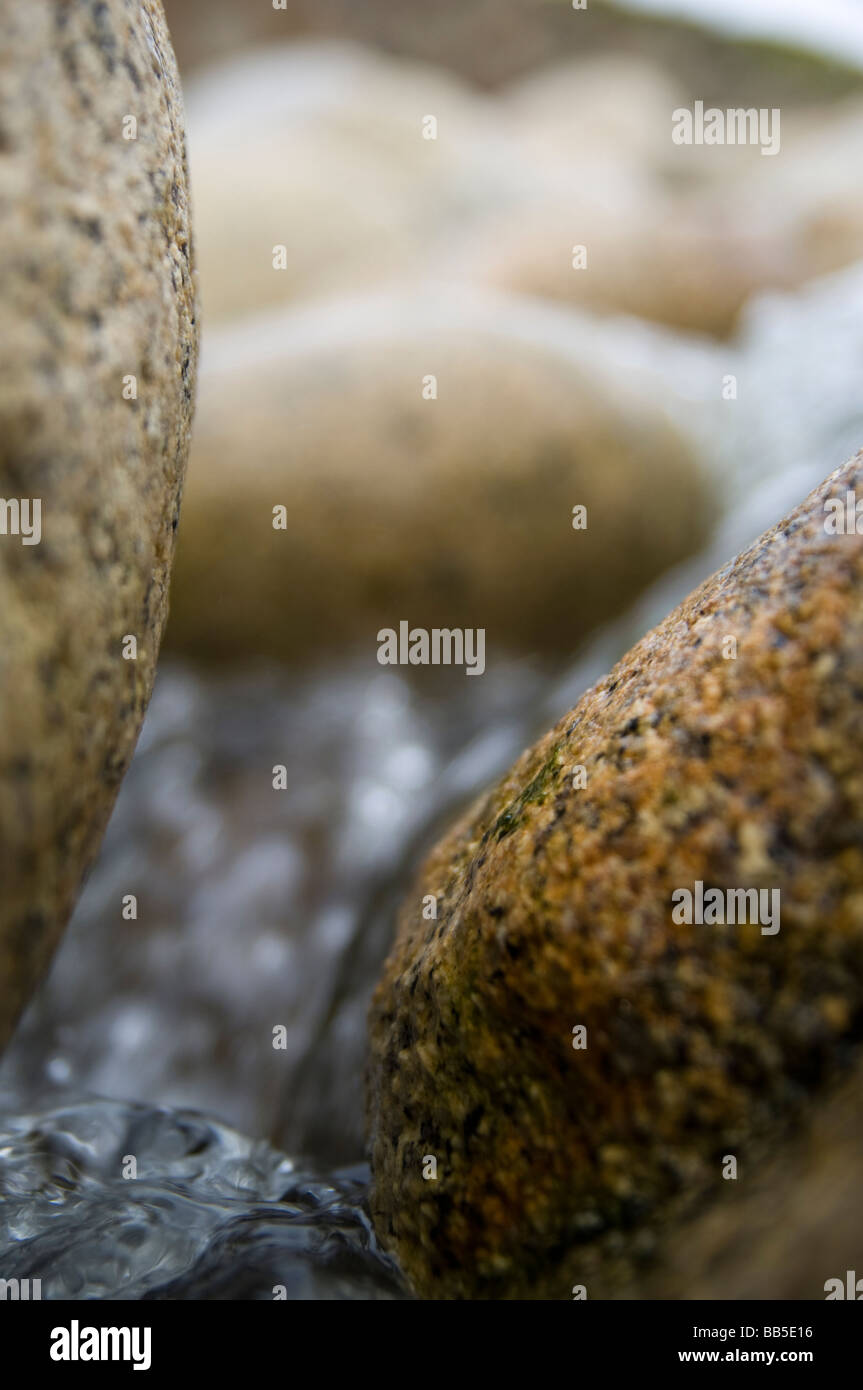 stream running through round stones Stock Photo - Alamy