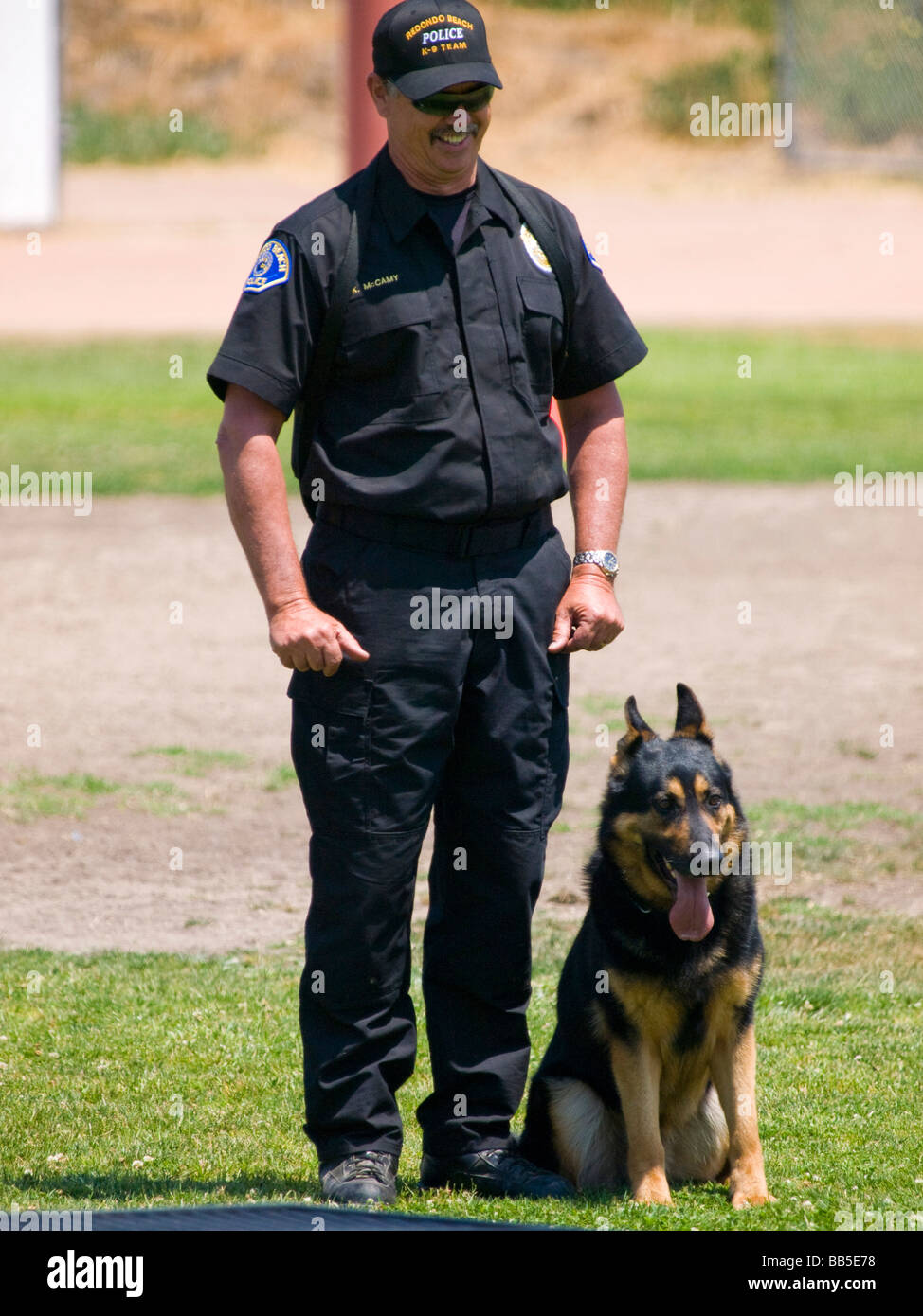 Police officer and his police dog stand at the ready for the next phase ...