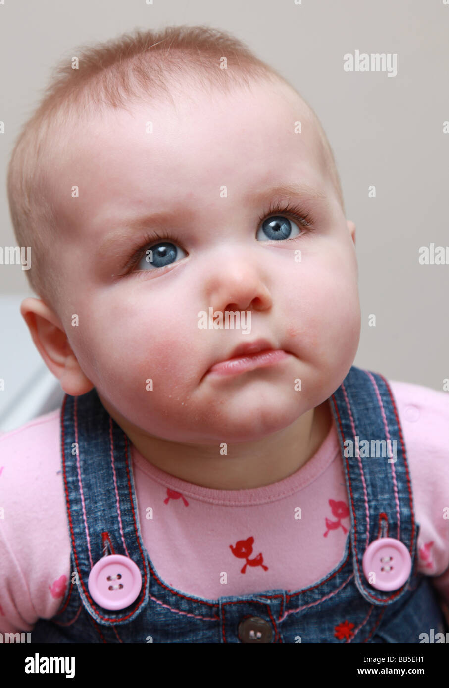 Baby girl frowning Stock Photo - Alamy