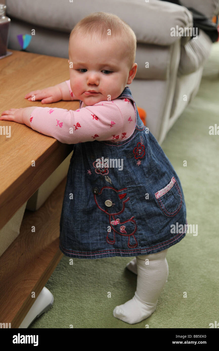Baby girl learning to walk Stock Photo - Alamy