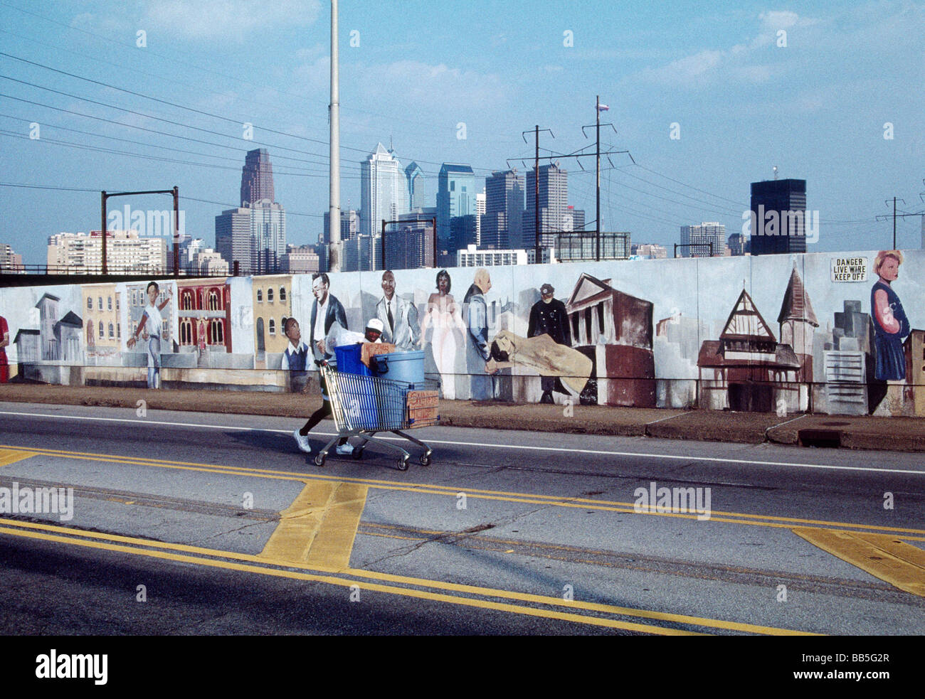 Juice vendor pushes a trolleyful of belongings across the Spring Garden ...