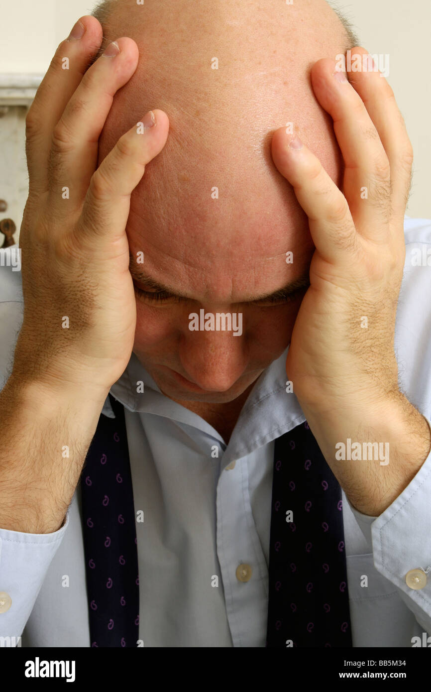 male looking gloomy with head in hands Stock Photo - Alamy
