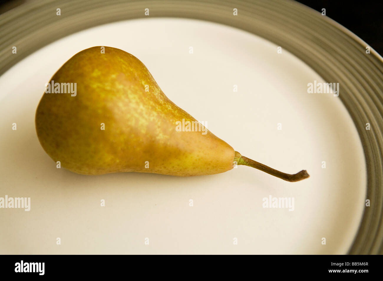 a pear on the plate Stock Photo - Alamy