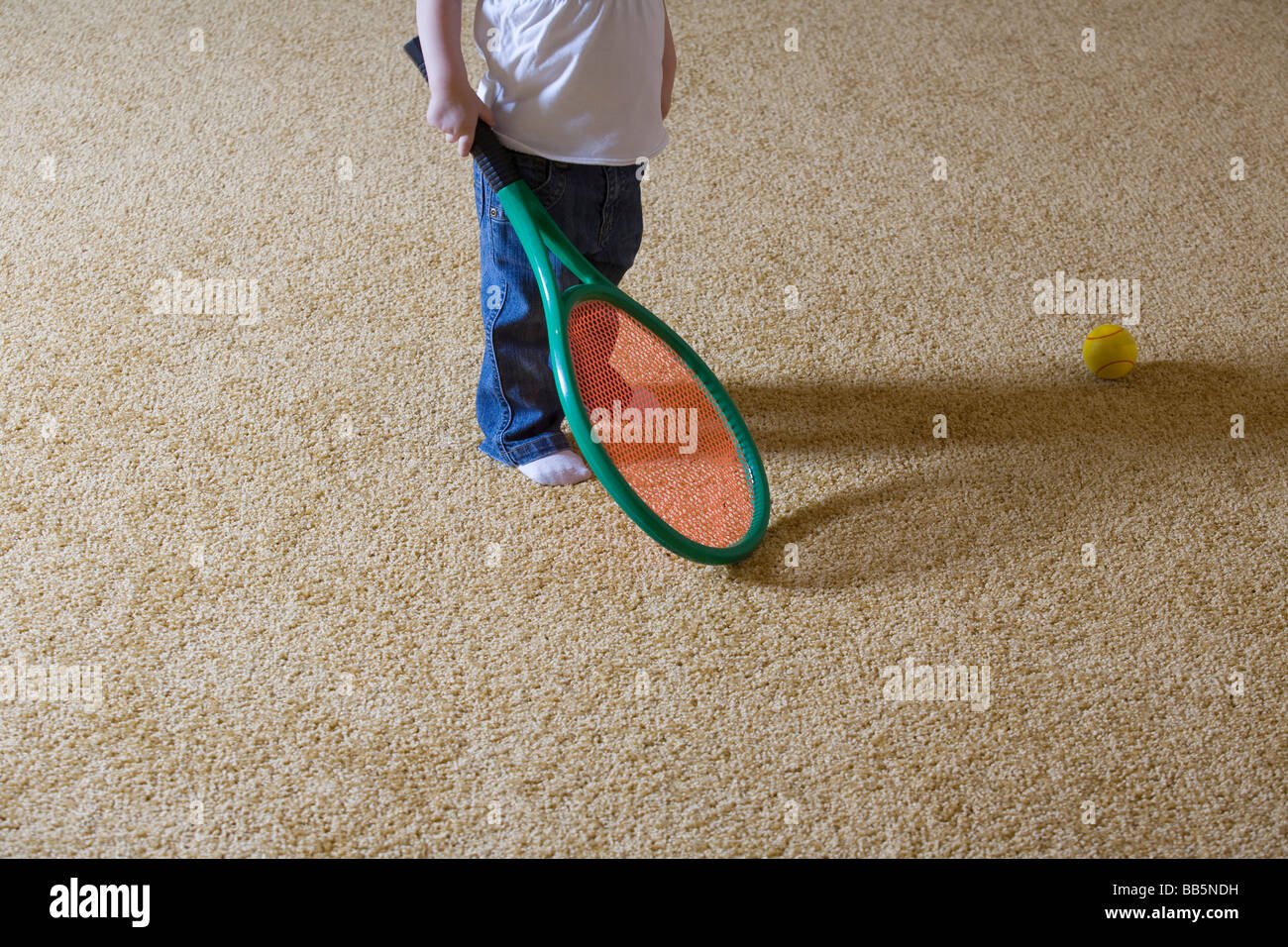 Baby girl holding tennis racket Stock Photo - Alamy