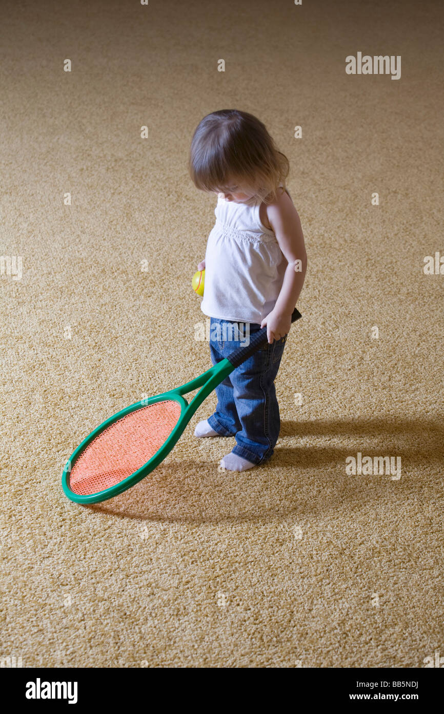 Baby girl holding tennis racket Stock Photo - Alamy
