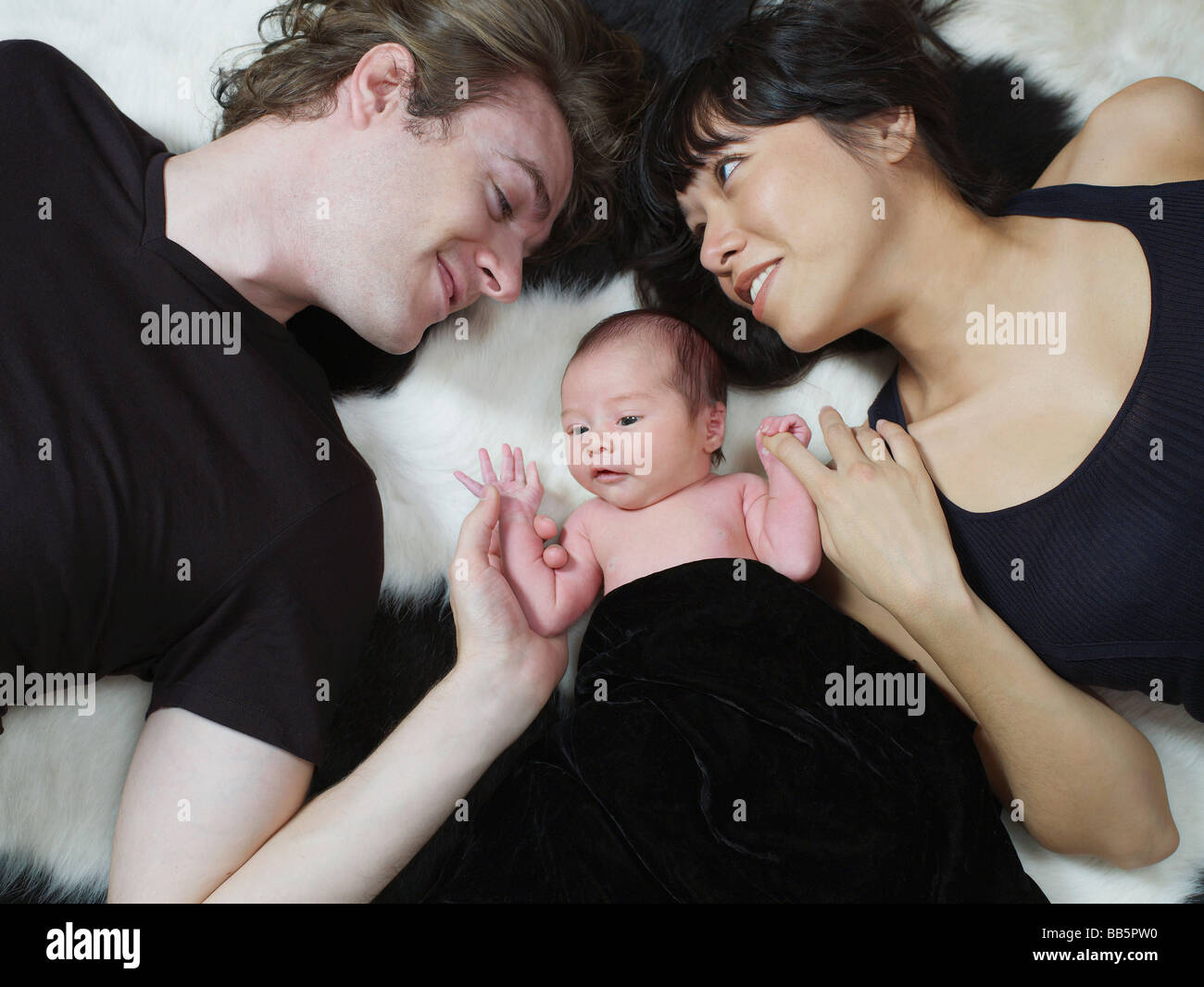 Mother and father bonding with newborn Stock Photo - Alamy