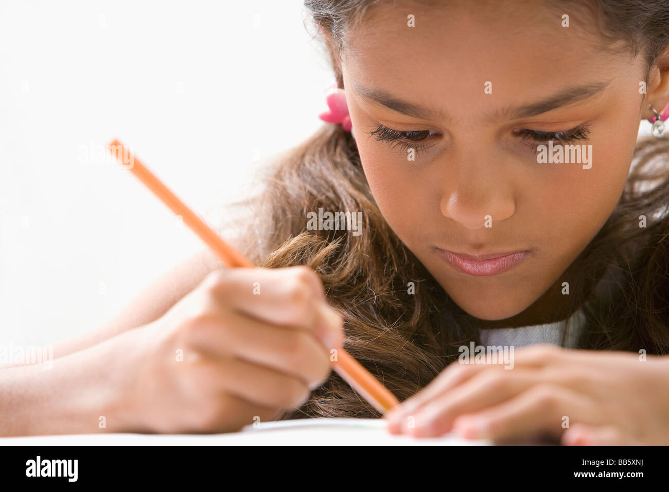 Mixed race girl doing homework Stock Photo - Alamy