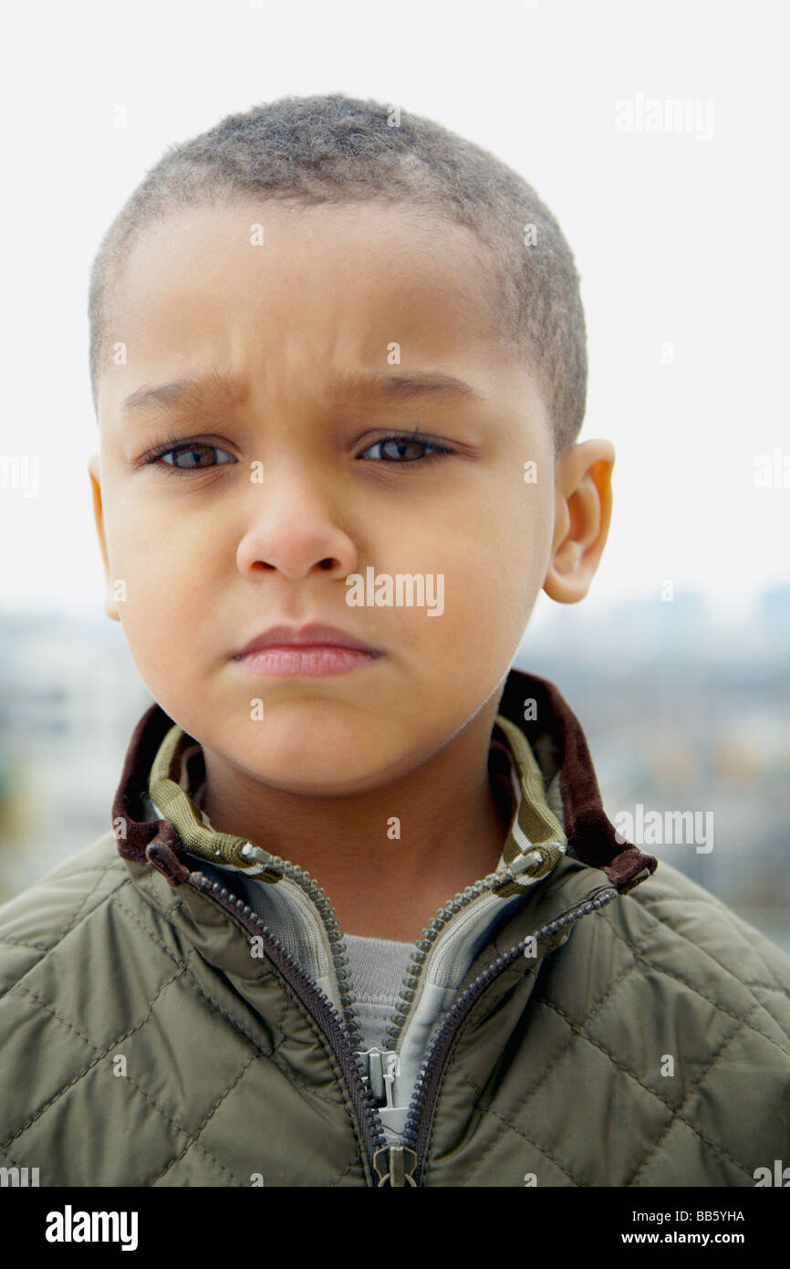 Mixed race boy frowning Stock Photo - Alamy