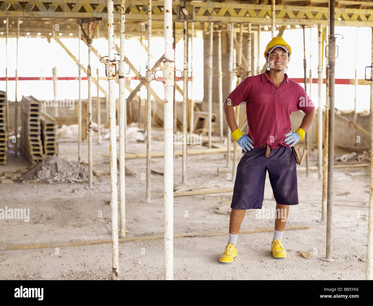 Hispanic worker standing on construction site Stock Photo - Alamy