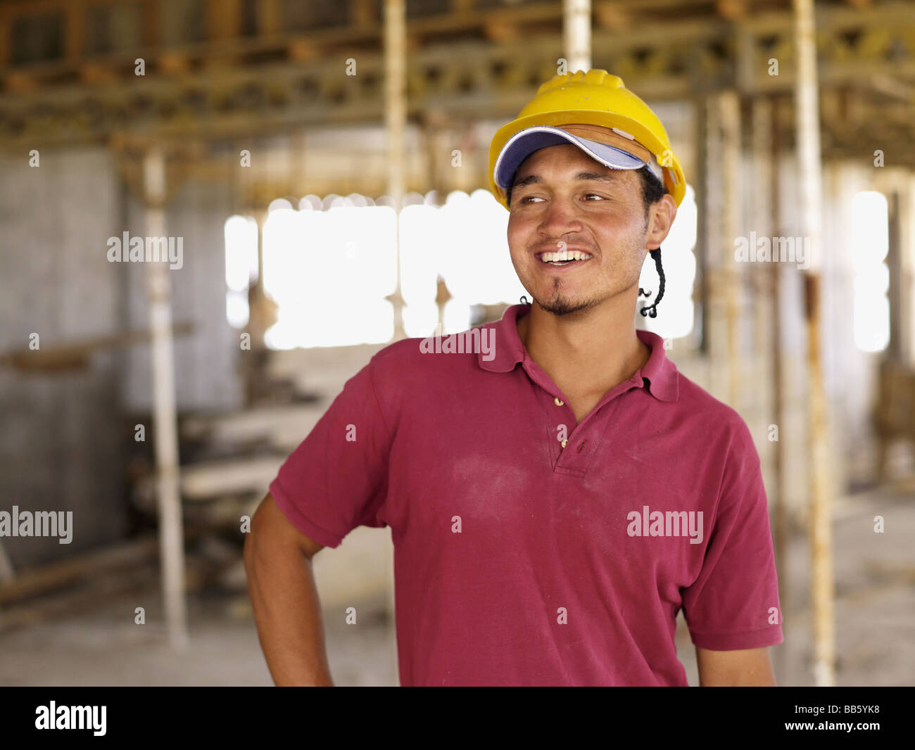 Hispanic worker smiling on construction site Stock Photo - Alamy