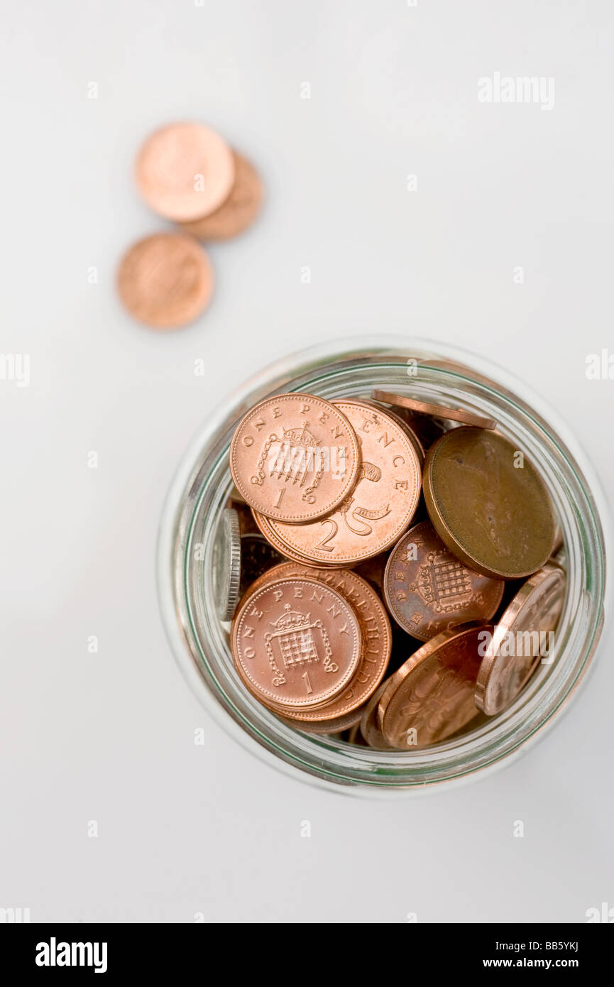 Loose change: a jam jar overflowing with British coins. Picture by Jim ...