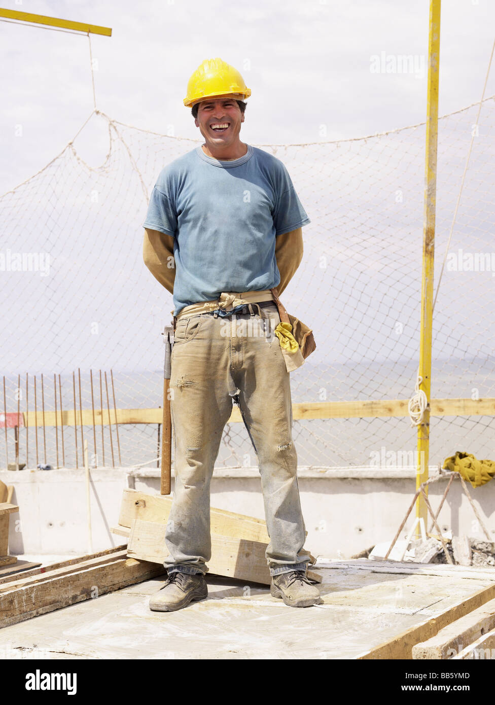 Hispanic worker smiling on construction site Stock Photo - Alamy
