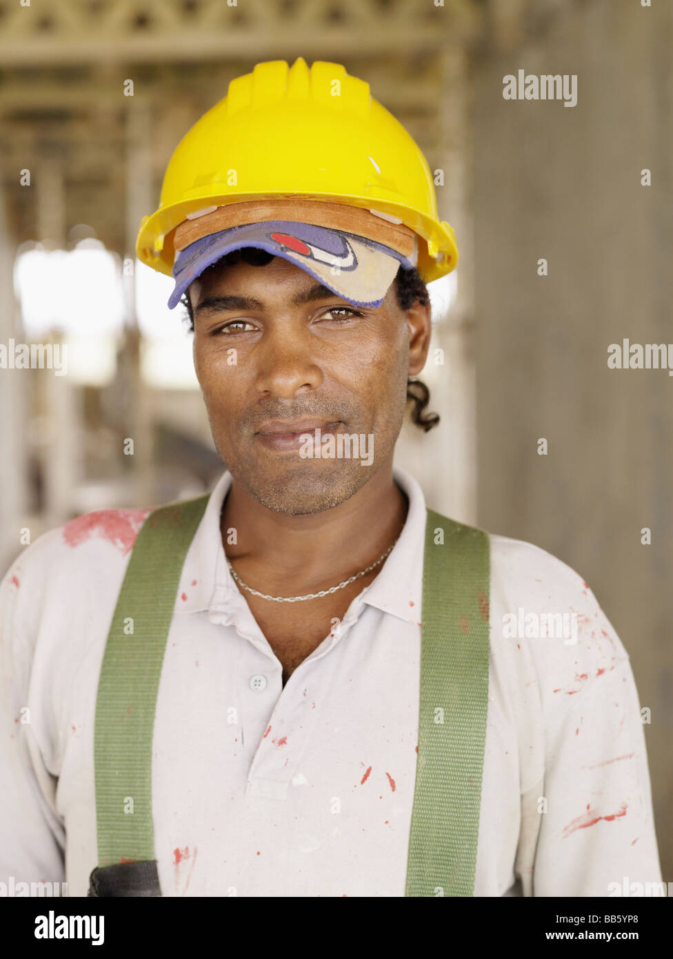 Hispanic worker smiling on construction site Stock Photo - Alamy