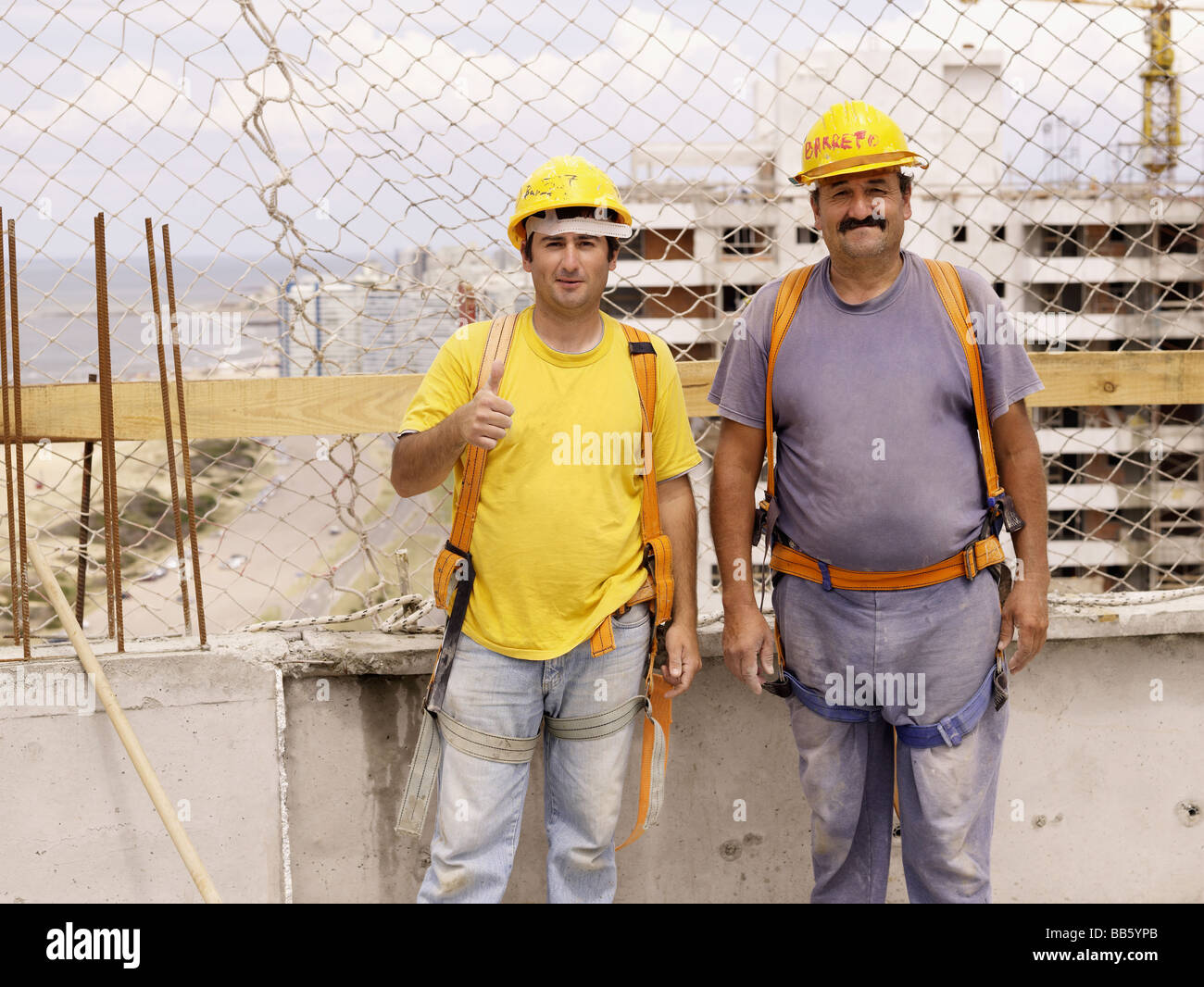 Hispanic workers smiling on construction site Stock Photo - Alamy
