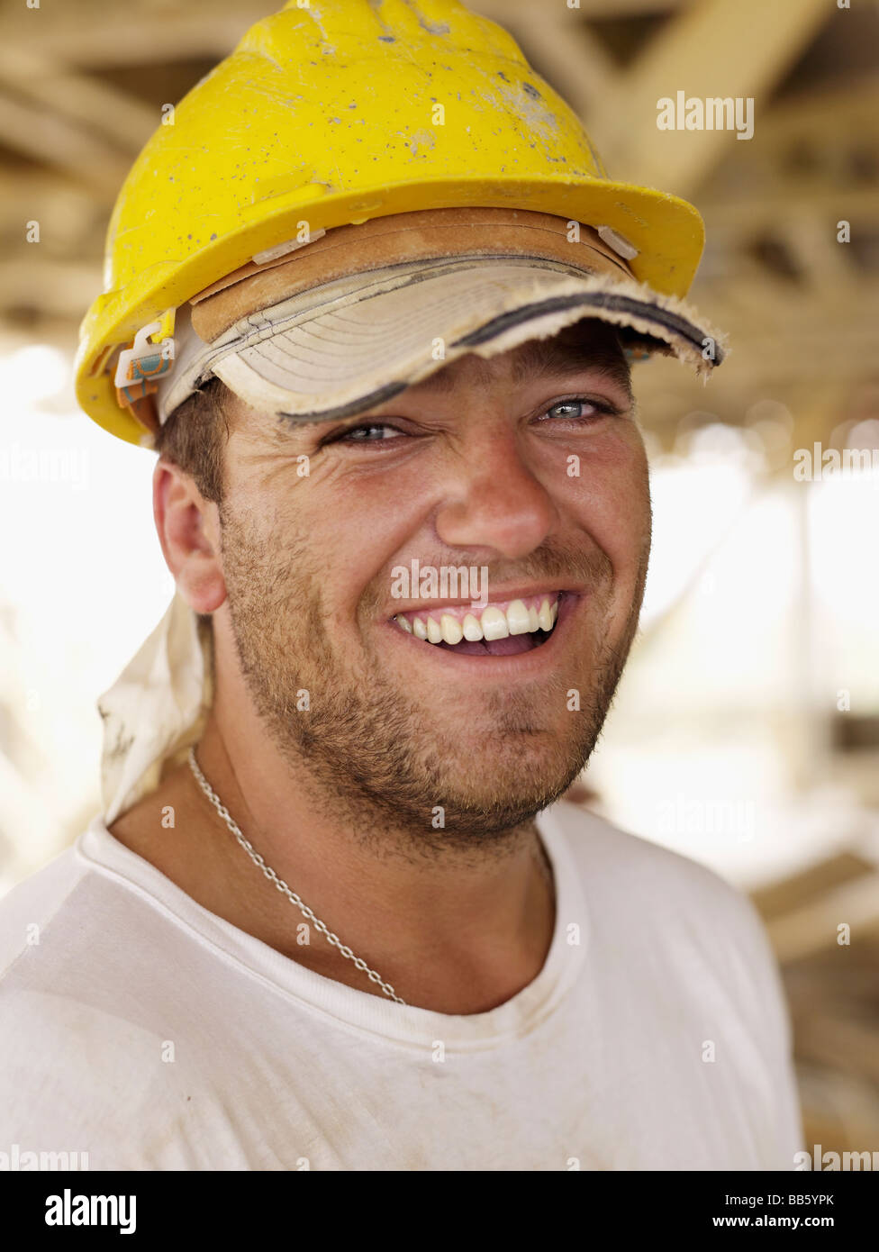 Hispanic worker smiling on construction site Stock Photo - Alamy