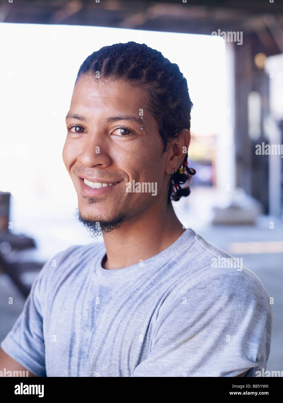 Hispanic worker smiling in factory Stock Photo - Alamy