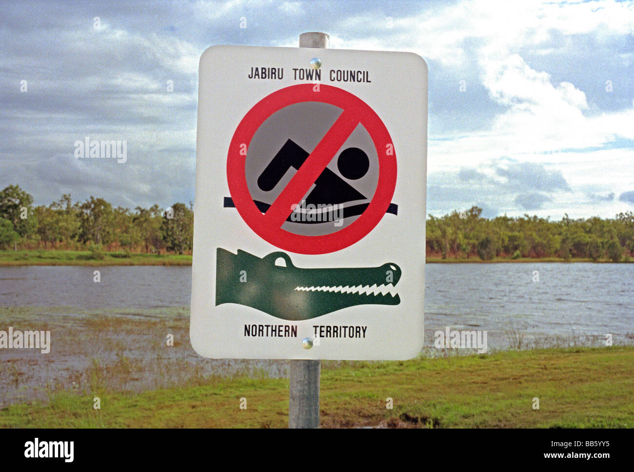 Crocodile warning sign at rivers edge Stock Photo - Alamy