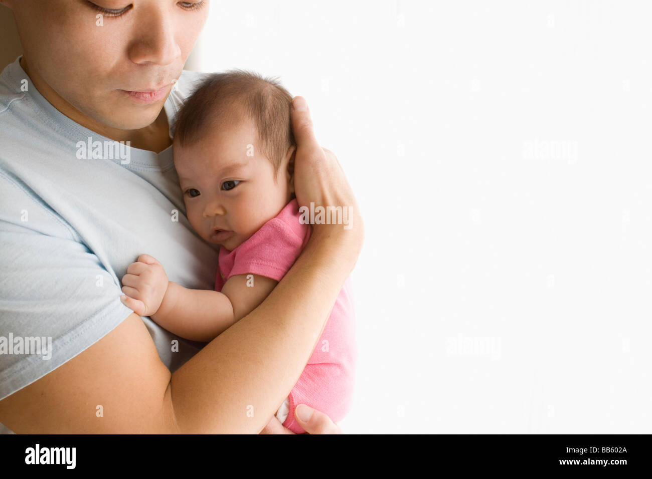 Chinese father holding baby daughter Stock Photo - Alamy