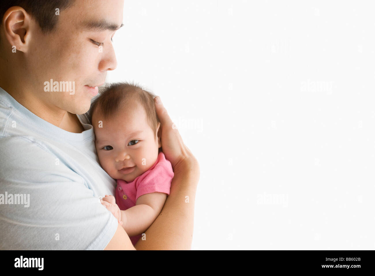 Chinese father holding baby daughter Stock Photo - Alamy
