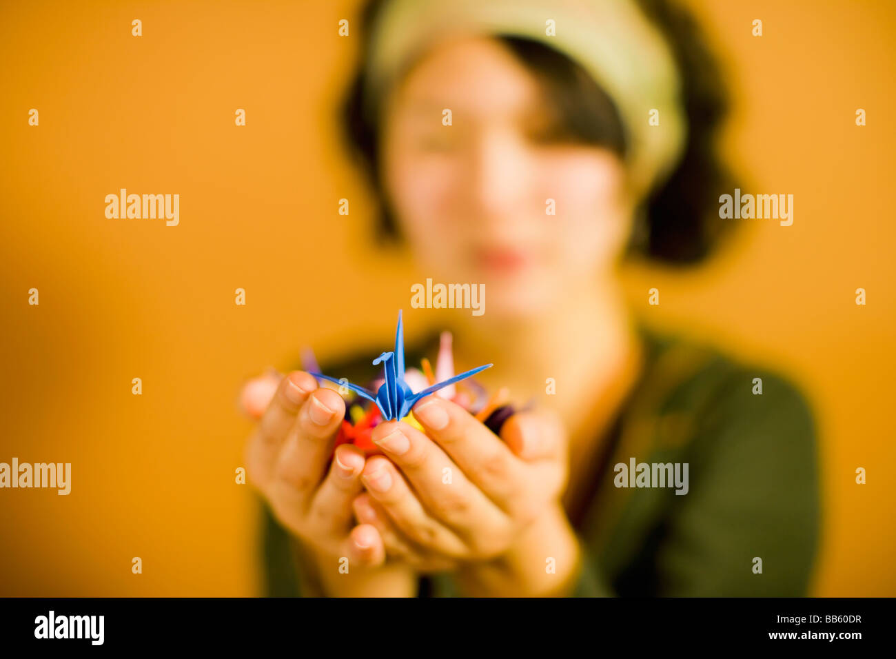 Japanese woman holding origami bird Stock Photo - Alamy
