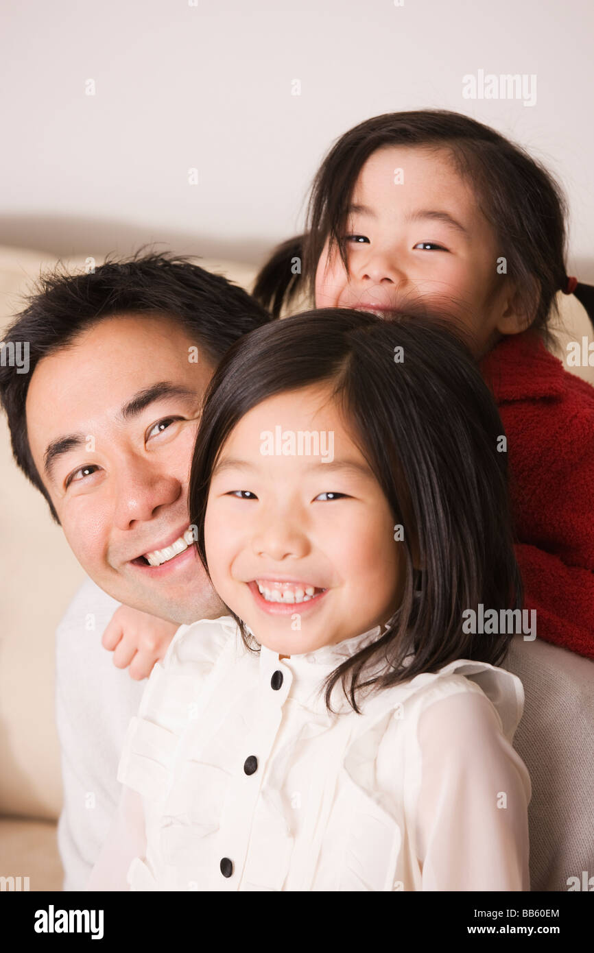 Asian father laughing with daughters Stock Photo - Alamy