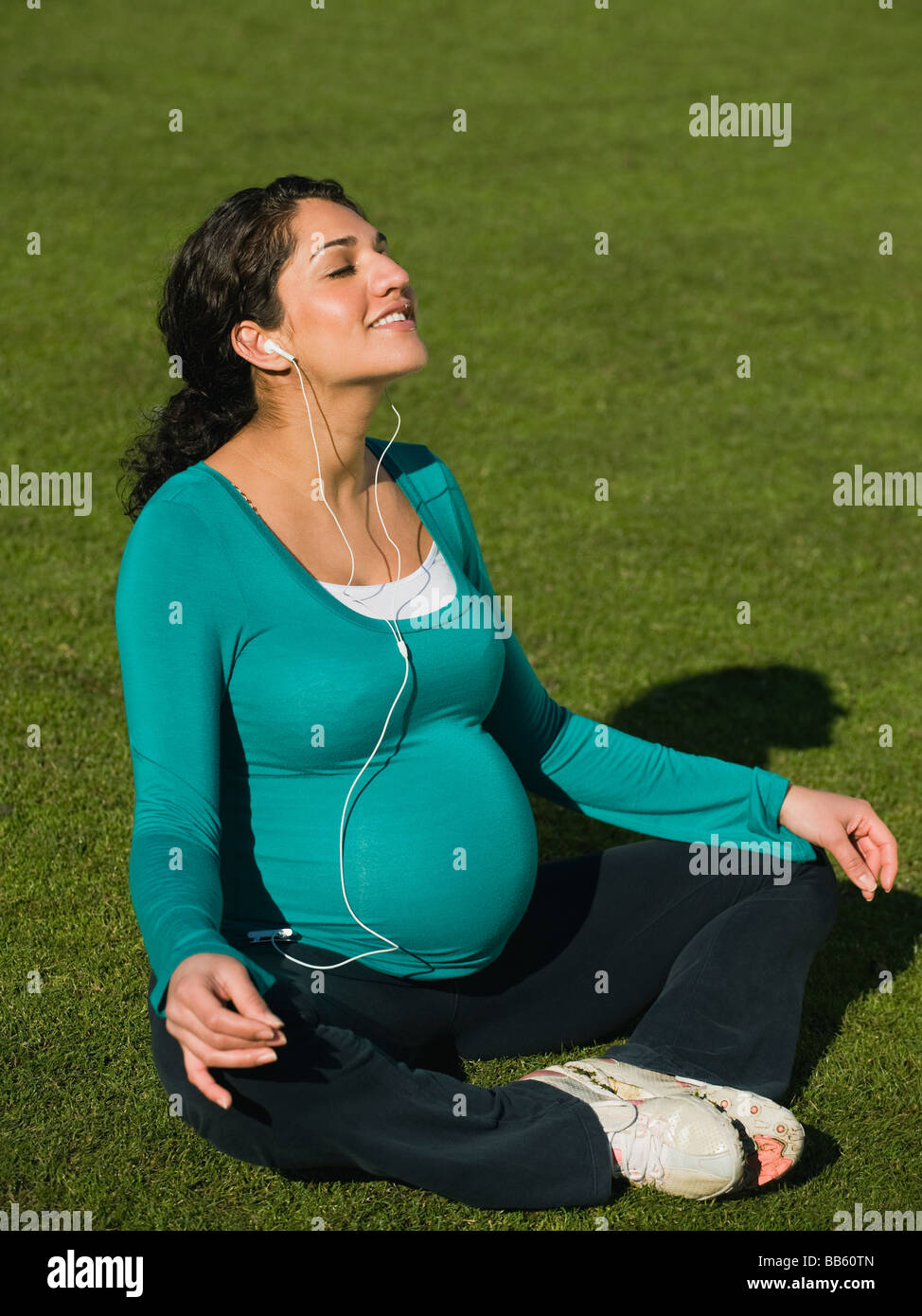 Pregnant Middle Eastern woman practicing yoga in park Stock Photo - Alamy
