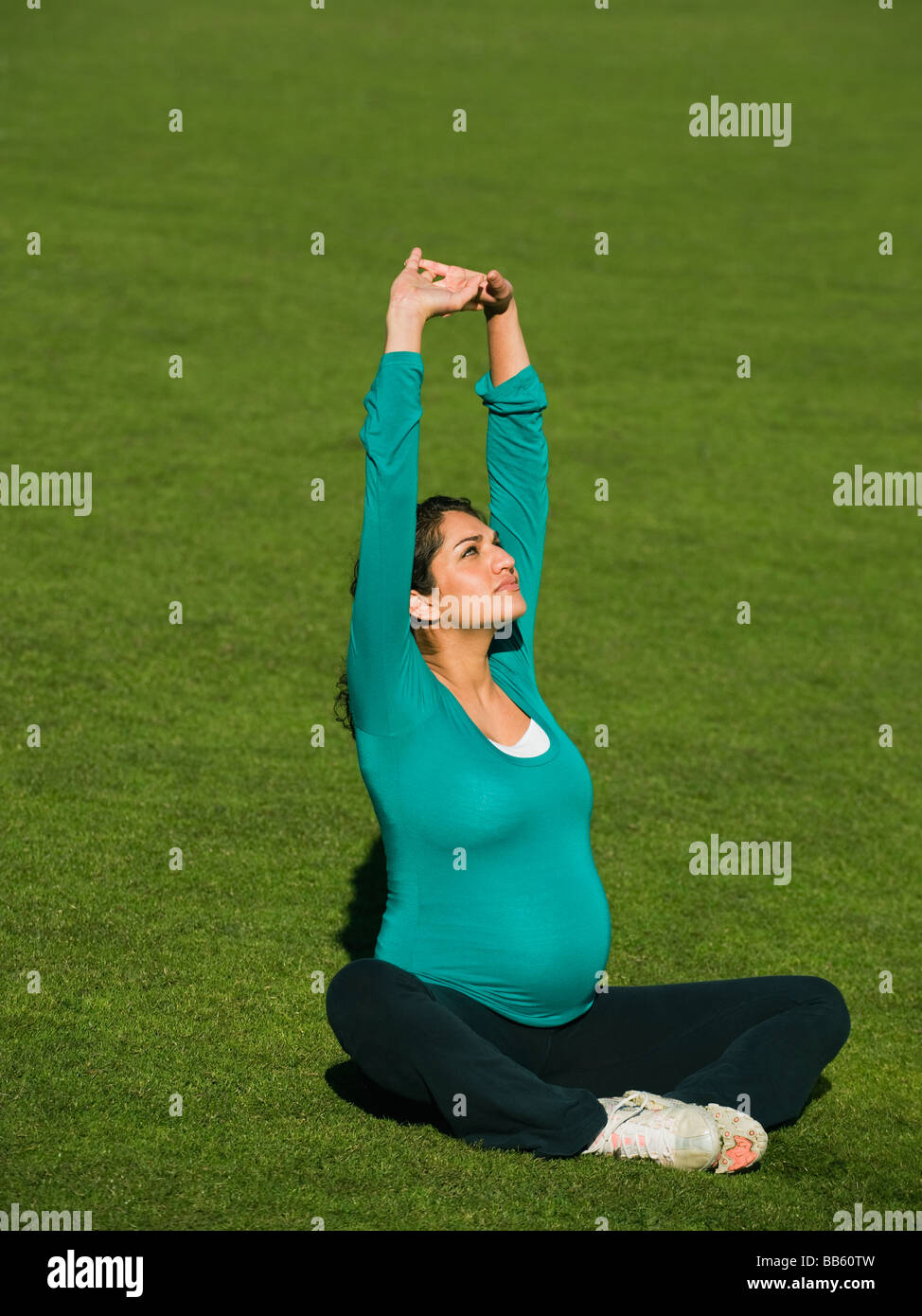 Pregnant Middle Eastern woman practicing yoga in park Stock Photo - Alamy